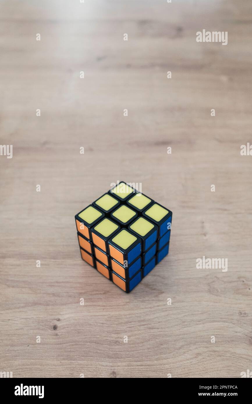 Yellow orange and blue perfect classic Rubik cube brain toy close up ...