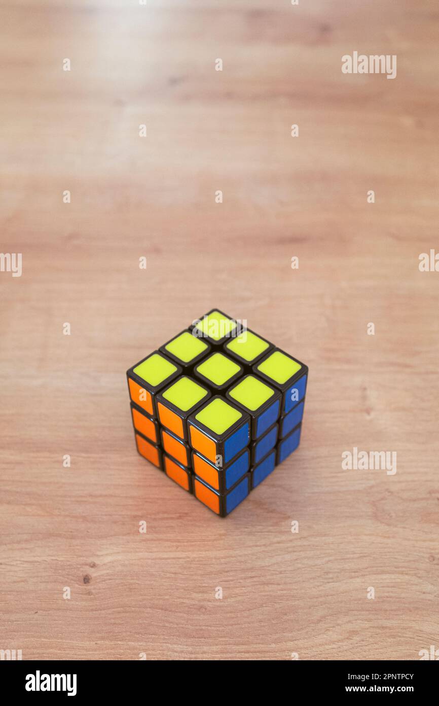 Yellow orange and blue perfect classic Rubik cube brain toy close up ...