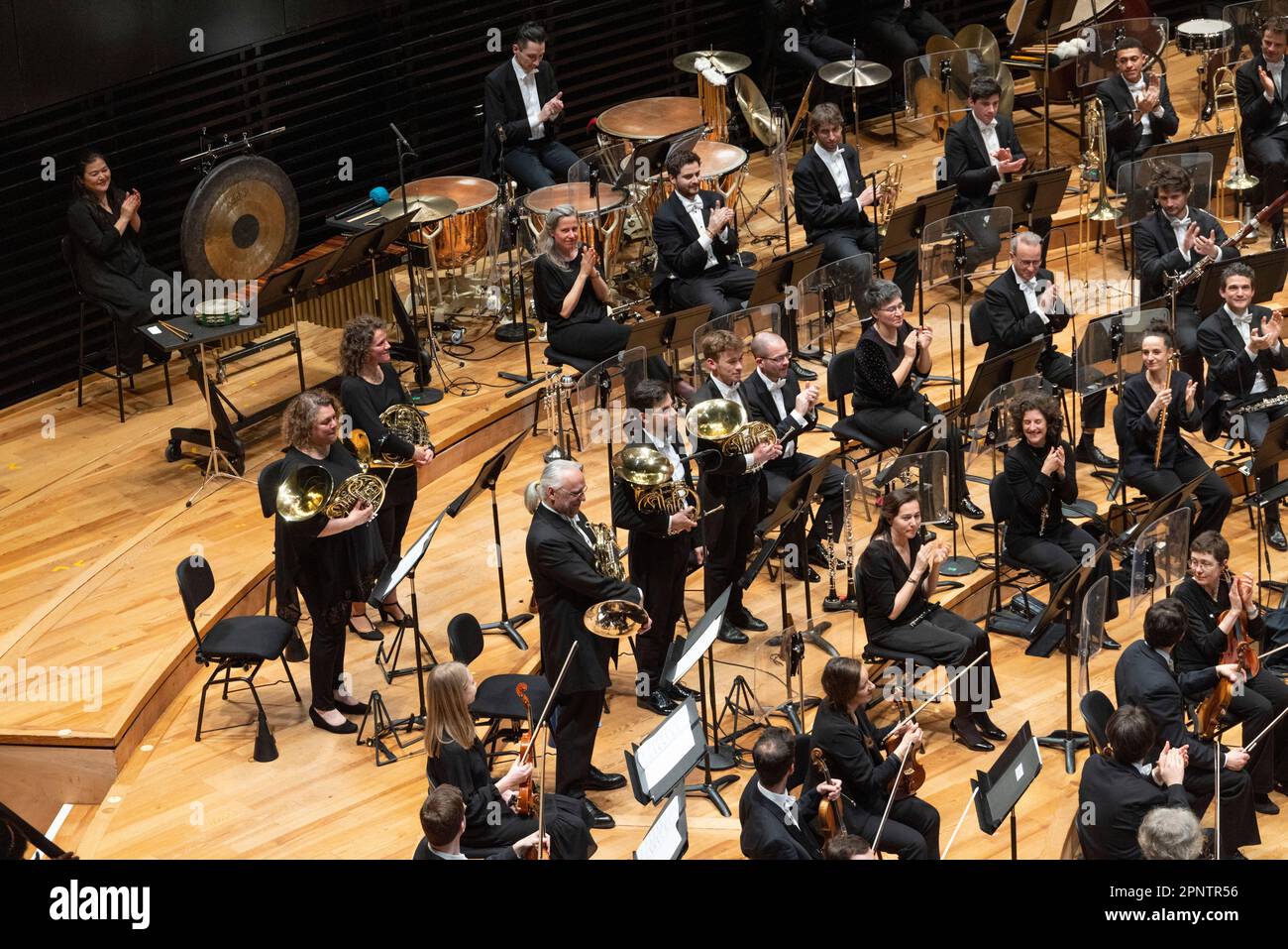 french horn players standing for applause, classical concert ...