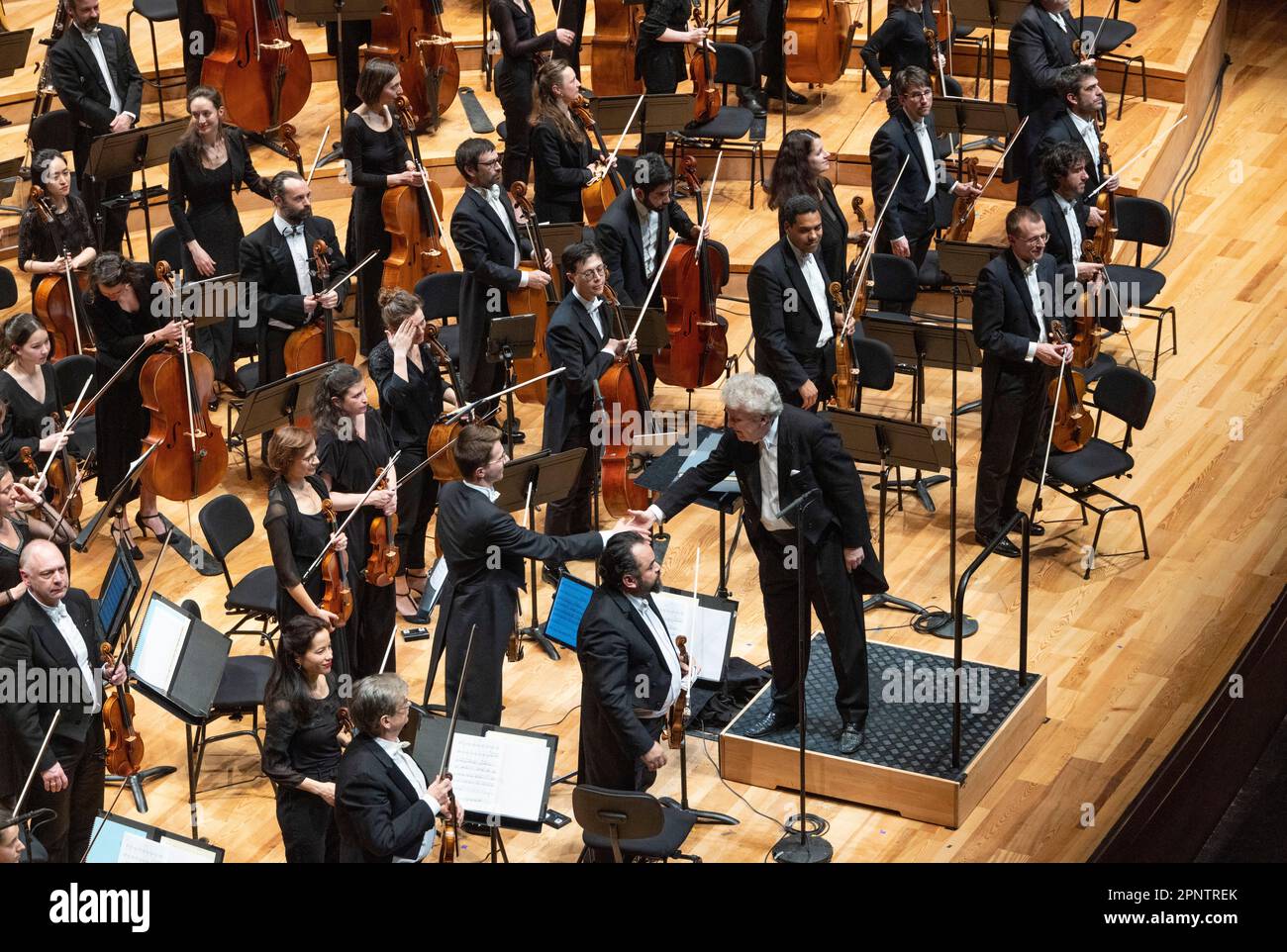 conductor Vassily Sinaisky shaking hands with violinist , classical ...