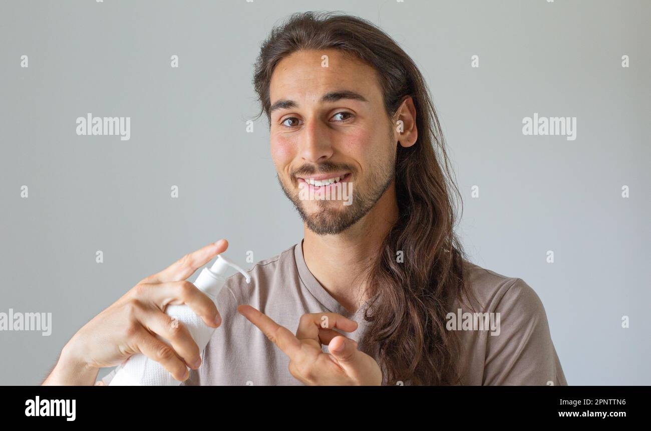 Long hair man face care Stock Photo - Alamy