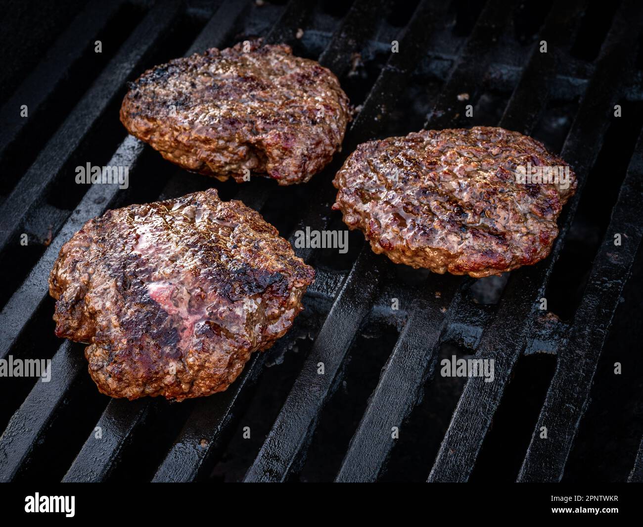 The classic simplicity of three plain burgers, cooked to perfection on ...