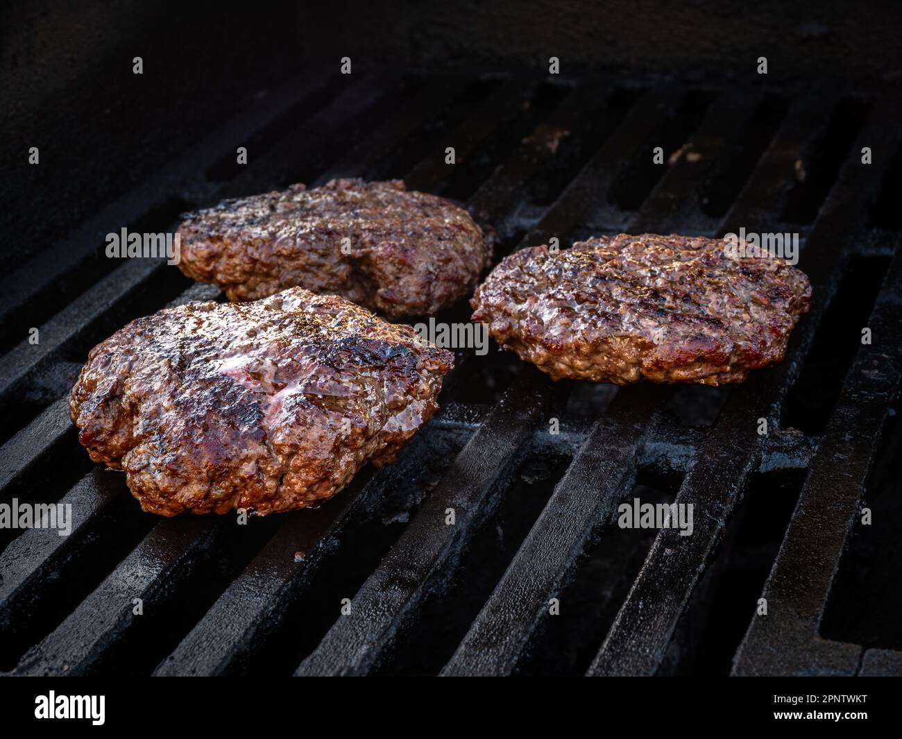 The classic simplicity of three plain burgers, cooked to perfection on ...