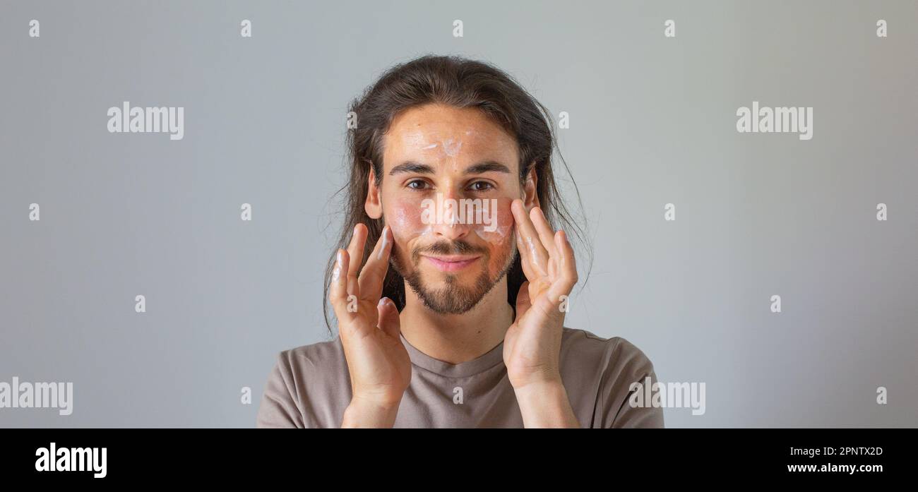 Long hair man face care Stock Photo - Alamy