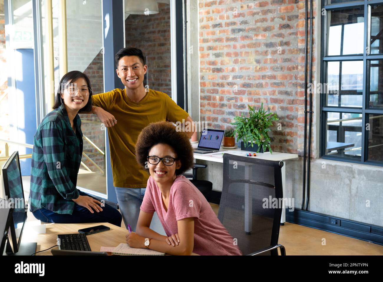 Group portrait of happy diverse creative colleagues smiling in casual ...