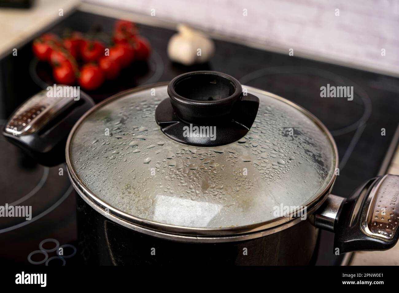 condensation drops on the glass lid of the kitchen pot boiling Stock ...