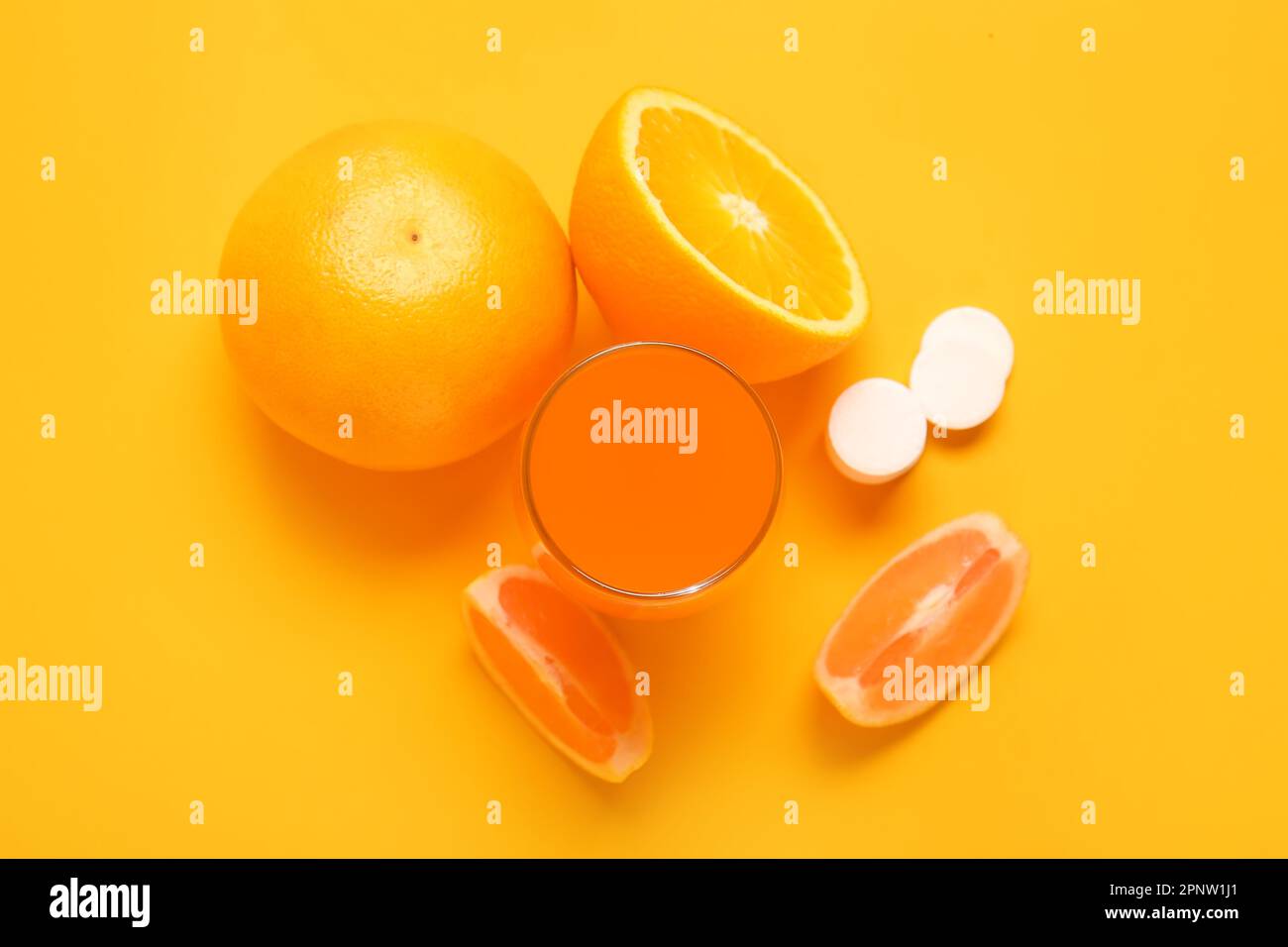 Glass of vitamin C effervescent tablet dissolved in water, orange and ...