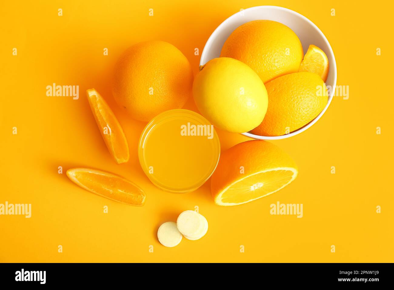 Glass of vitamin C effervescent tablet dissolved in water and fruits on ...