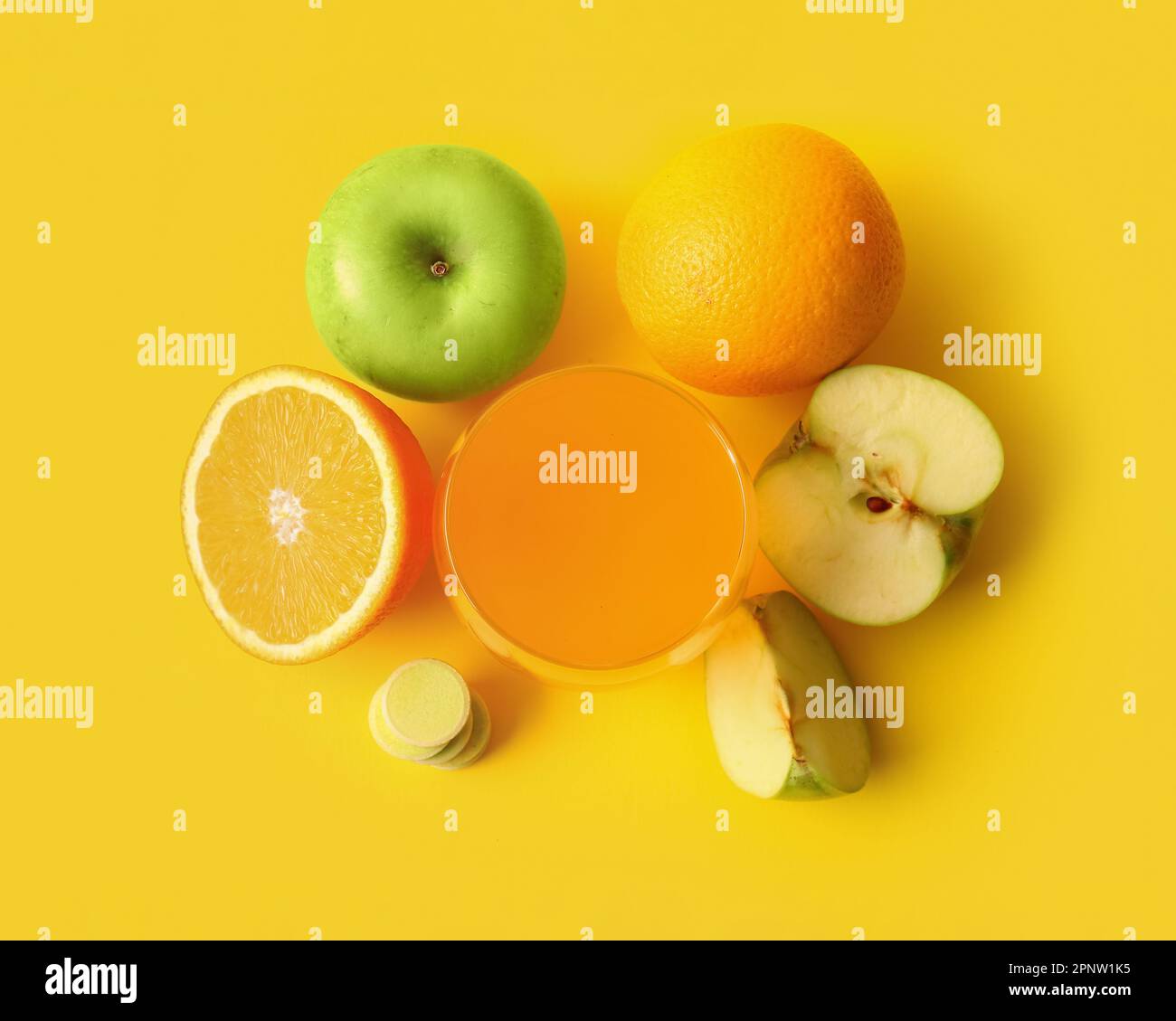 Glass of vitamin C effervescent tablet dissolved in water and fruits on ...