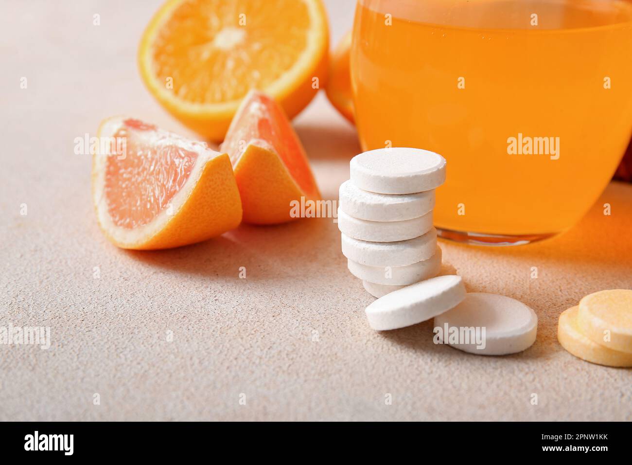 Vitamin C effervescent tablets and fruits on grey grunge table Stock ...