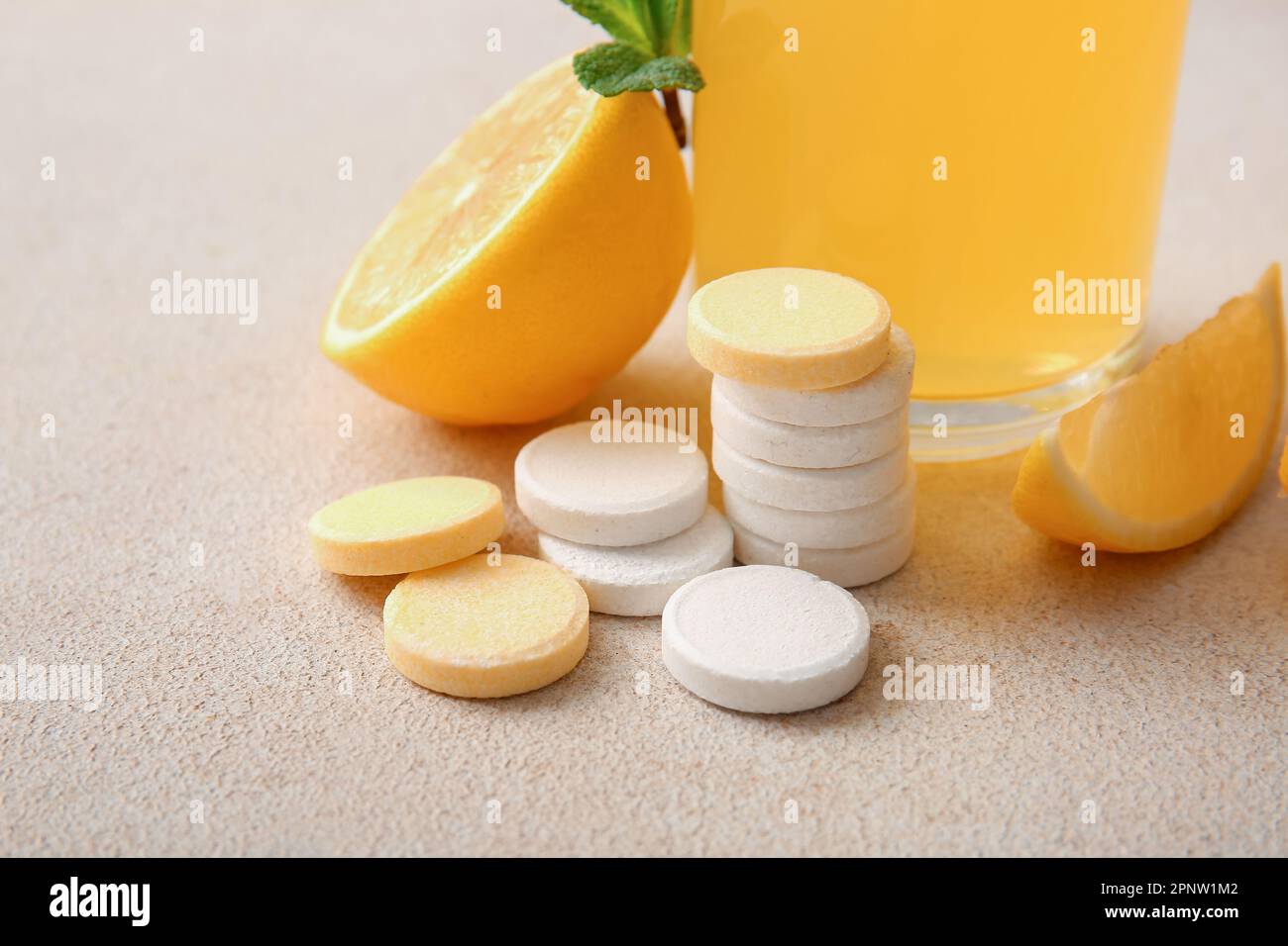 Vitamin C effervescent tablets and lemons on beige grunge table Stock ...