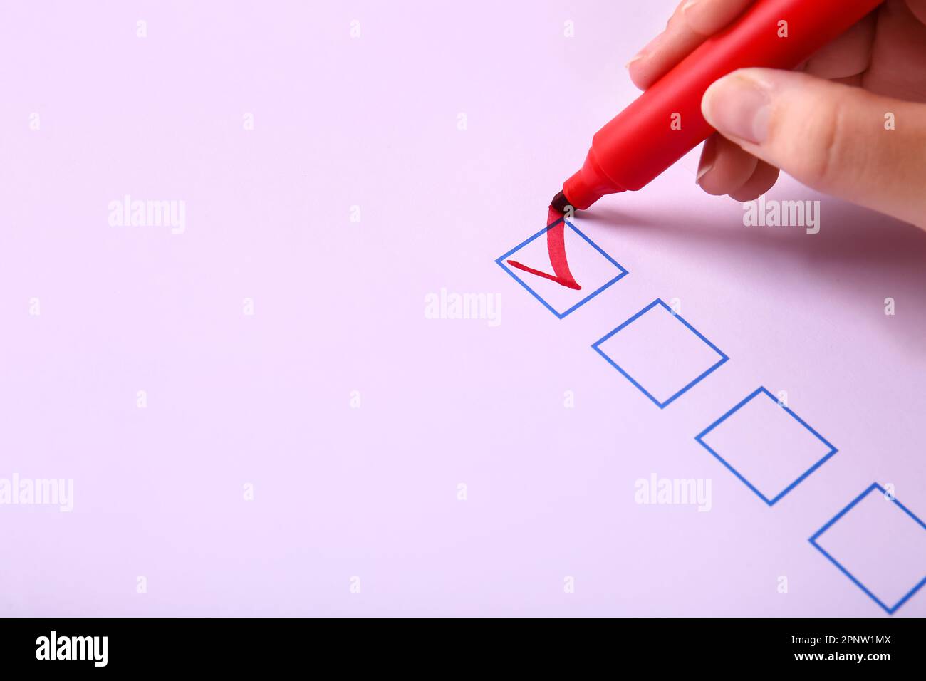 Woman marking on checklist box, closeup Stock Photo - Alamy