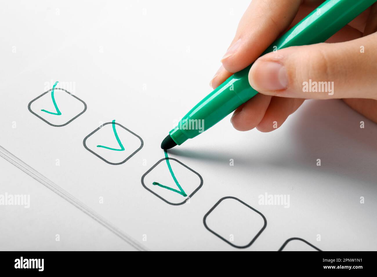 Woman marking on checklist box, closeup Stock Photo - Alamy