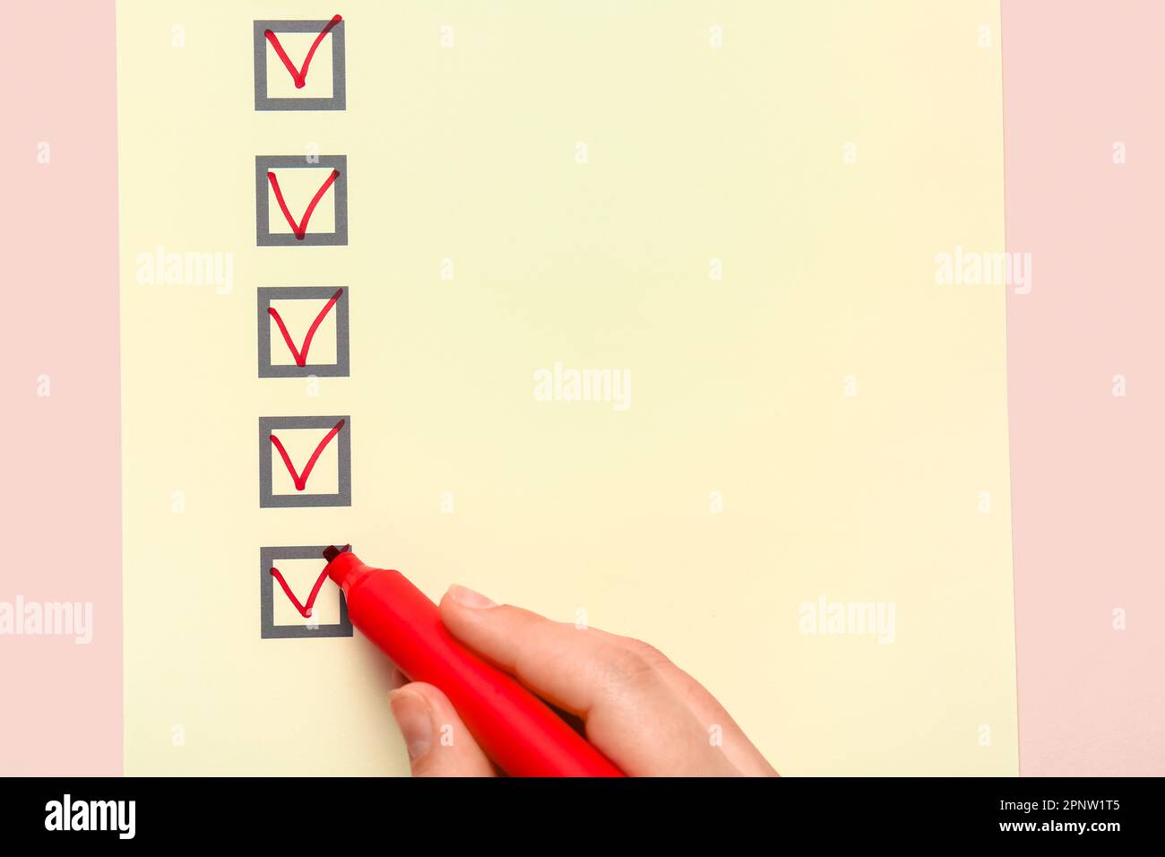 Woman marking on checklist box with red marker Stock Photo - Alamy