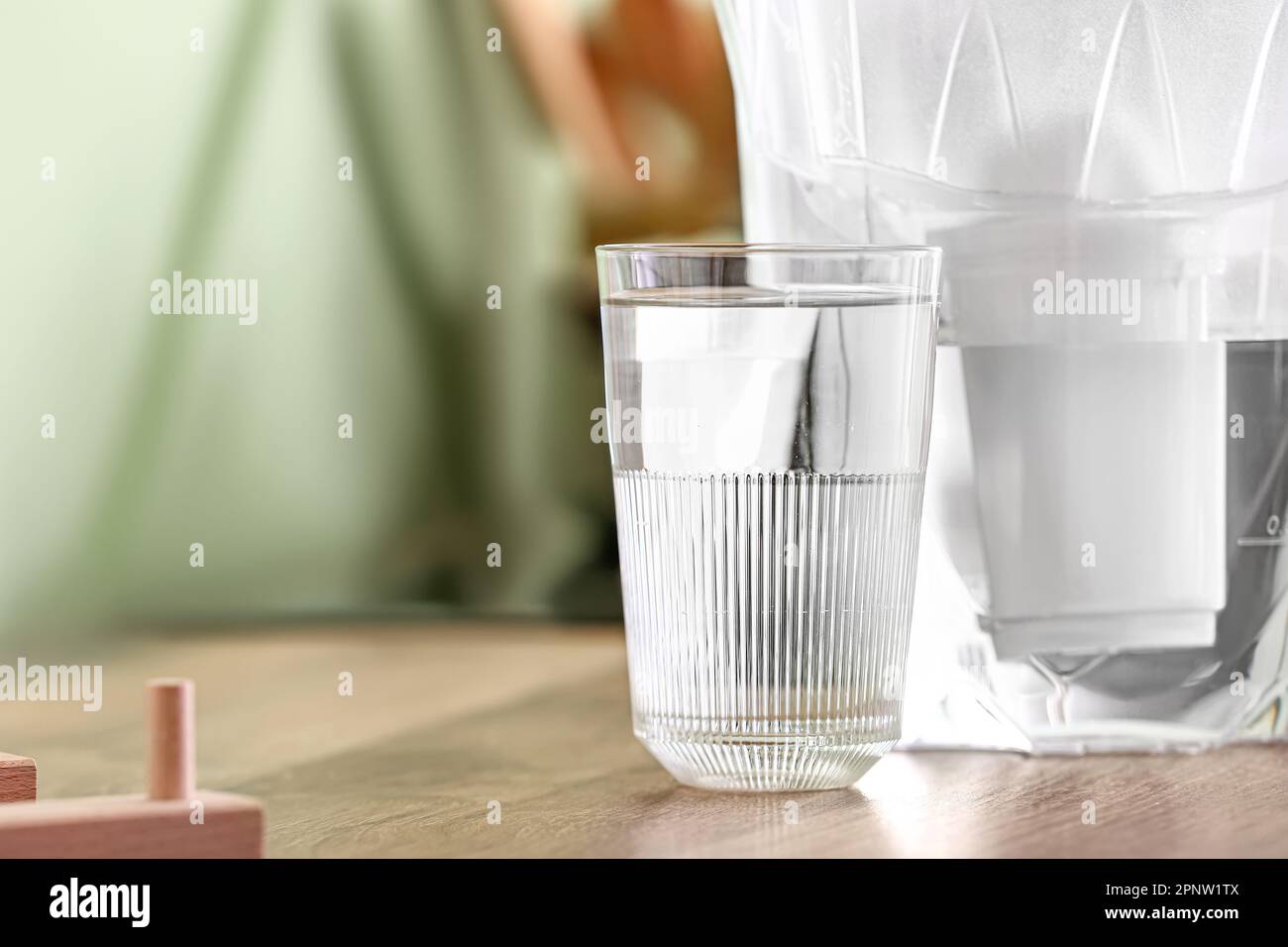 Glass of water near modern filter jug on kitchen counter, closeup Stock ...
