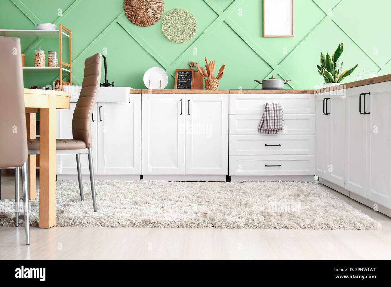 Interior of modern kitchen with white counters Stock Photo - Alamy