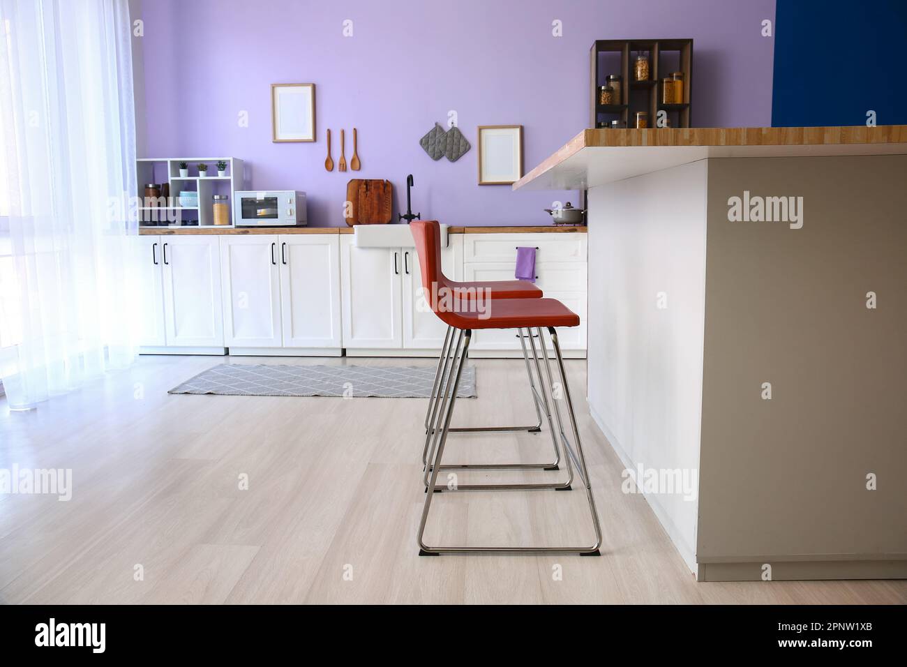 Interior of modern kitchen with table and white counters Stock Photo ...