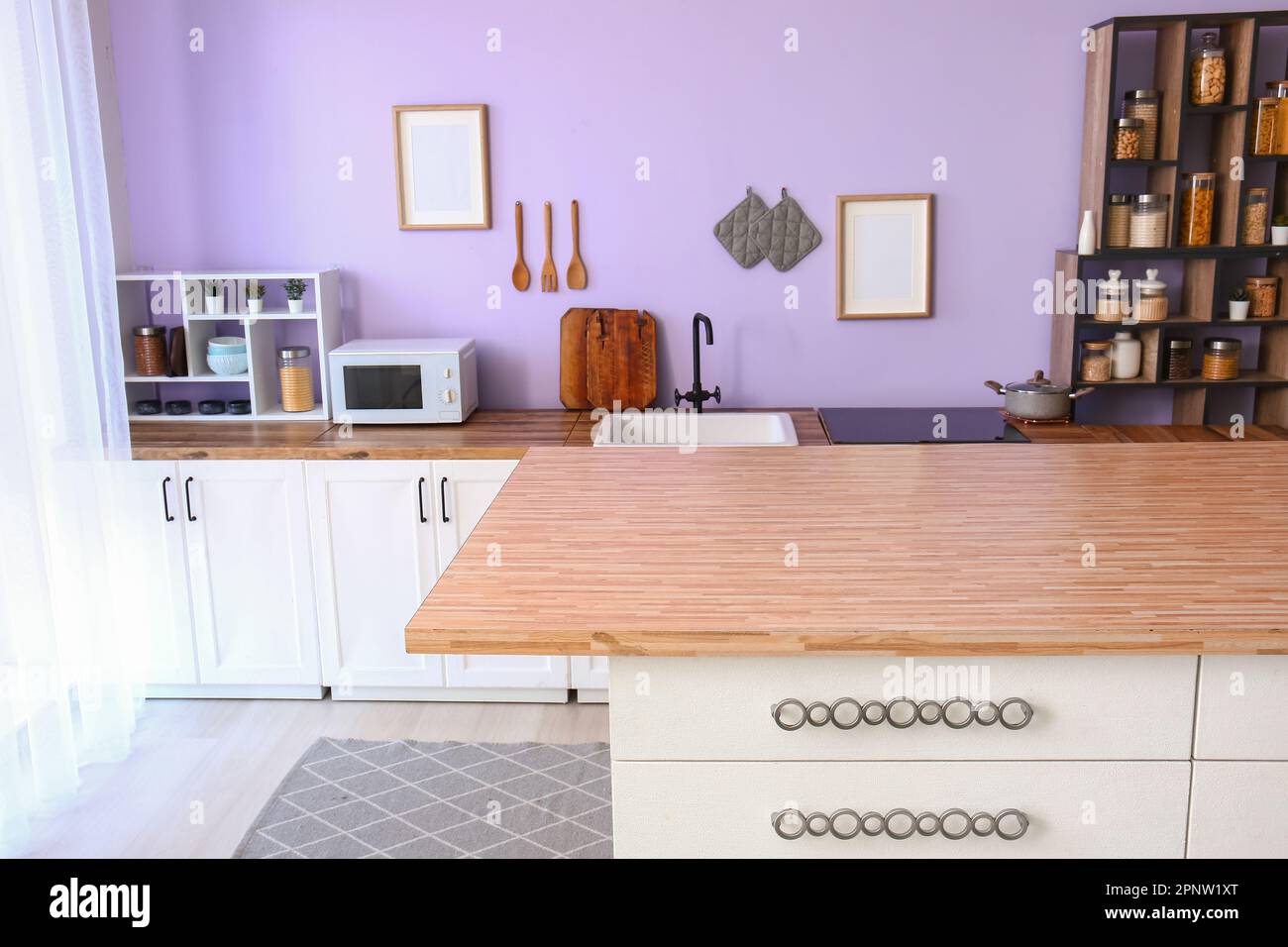 Interior of modern kitchen with clean table and white counters Stock ...