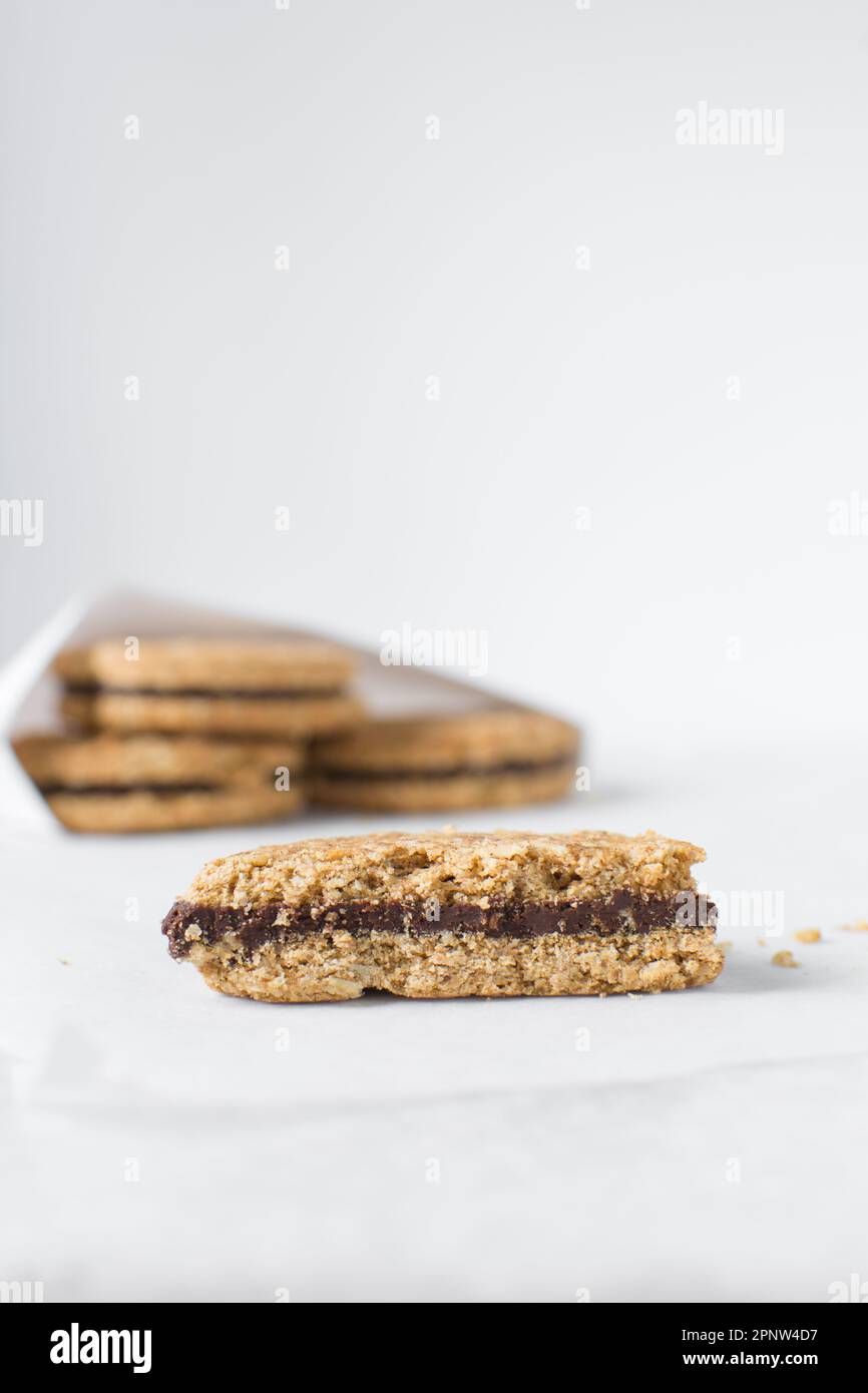 cookies packed in white parchment bags, chocolate filled oat cookies in ...