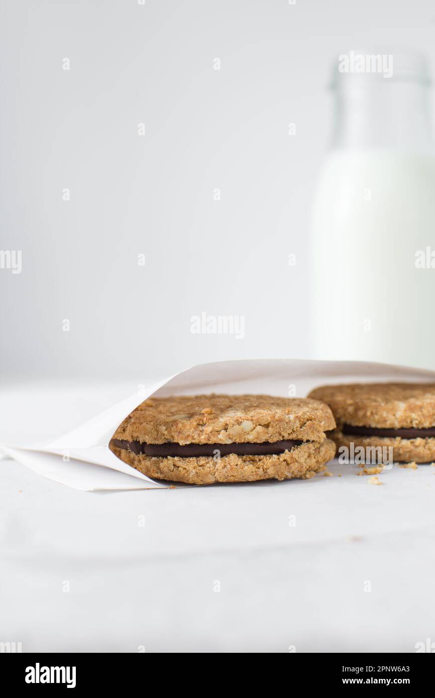 cookies packed in white parchment bags, chocolate filled oat cookies in ...