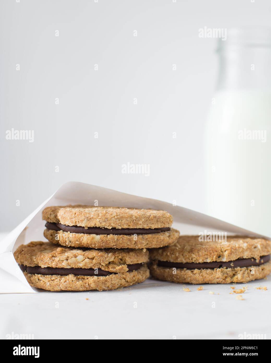 cookies packed in white parchment bags, chocolate filled oat cookies in ...