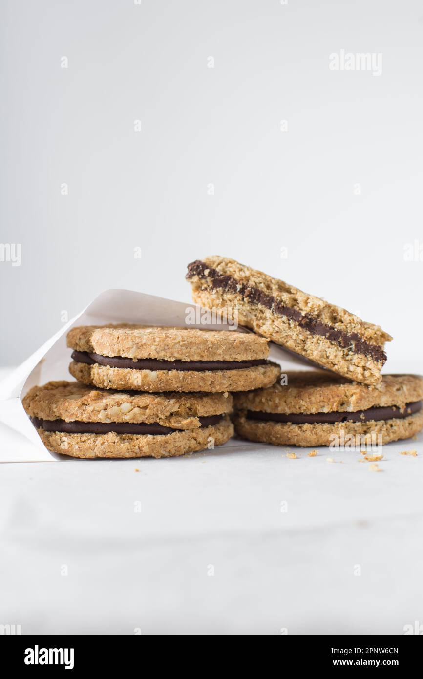 cookies packed in white parchment bags, chocolate filled oat cookies in ...