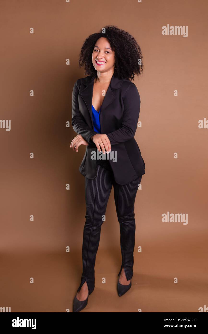 Business manager woman dressed in black blazer standing against brown ...
