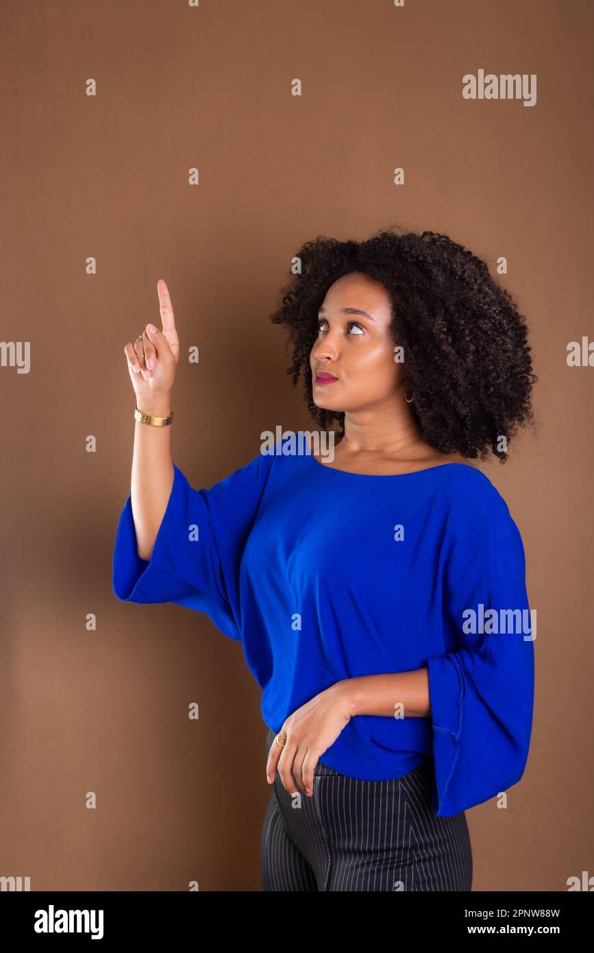 Beautiful young business woman making hand gestures. Standing against a ...