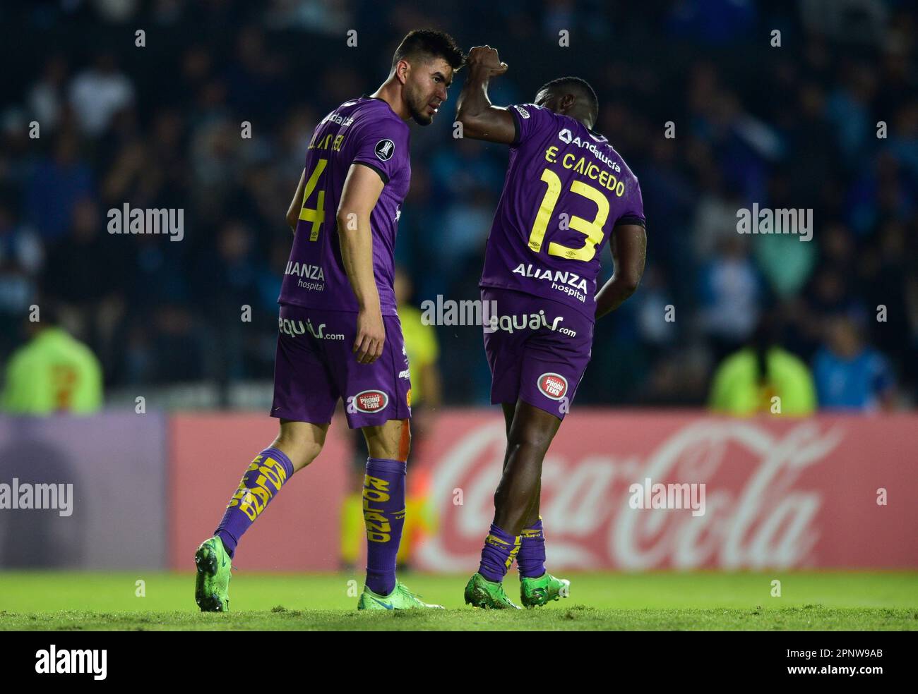 Wilker Angel of Ecuador's Aucas, left, reacts after scoring an own-goal as teammate Edison ...