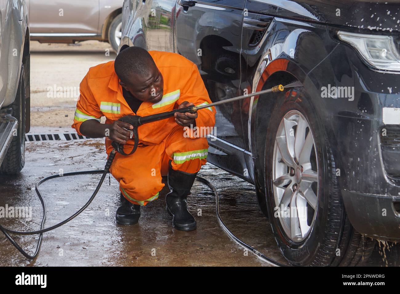 Tonderai Nidza rinses a car in Ruwa, Harare, Zimbabwe on January 23 ...
