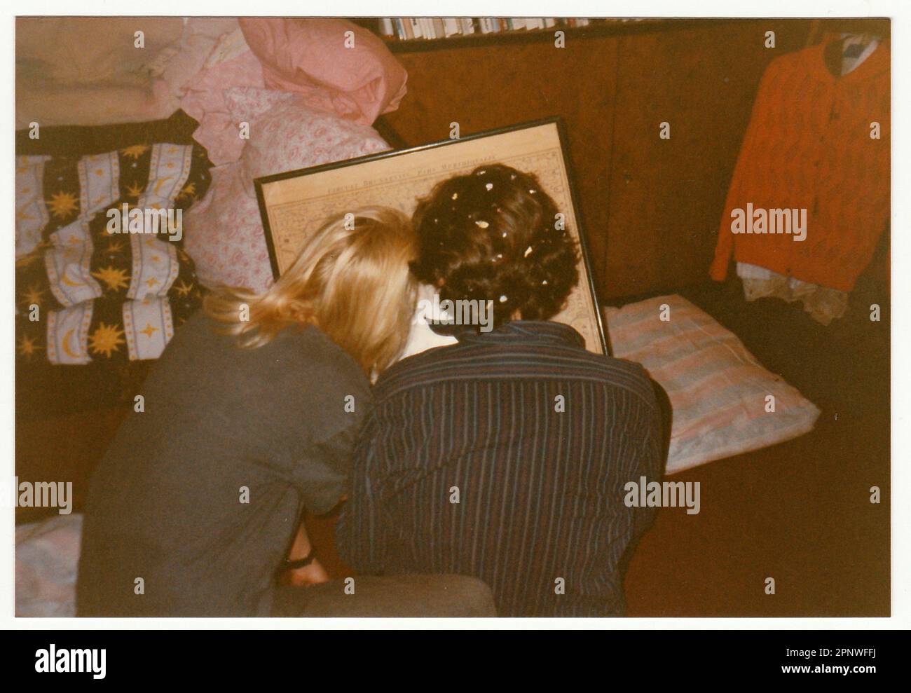 Retro photo shows boy and girl look at the picture-map Stock Photo - Alamy