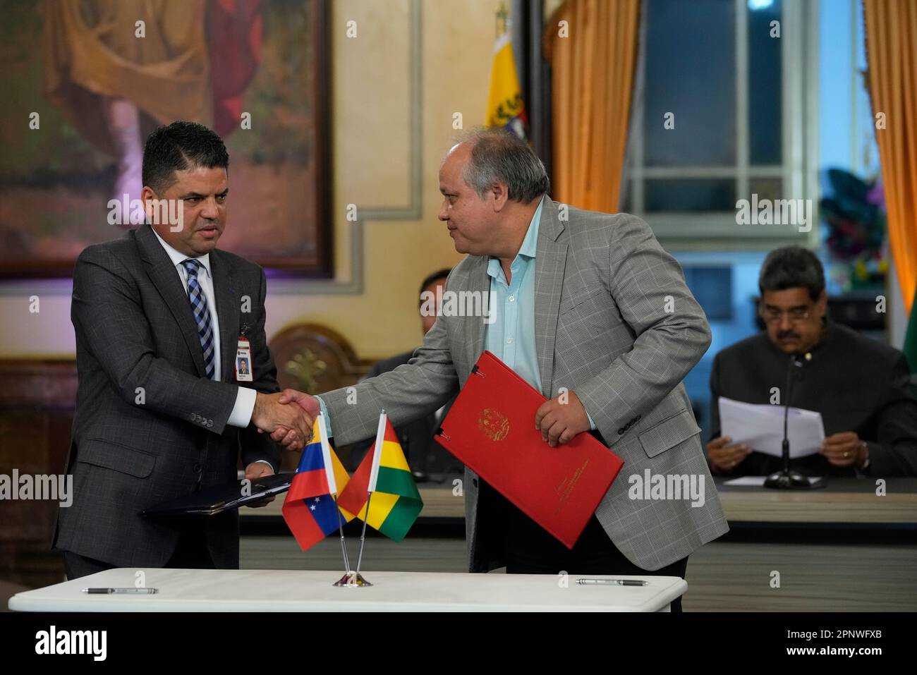 Venezuela's Vice President of Gas de PDVSA Juan Santana, left, shakes hands with Bolivia's ...