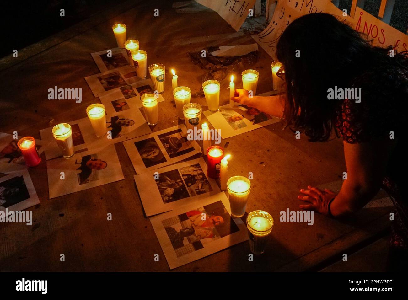 A reporter from Chilpancingo de los Bravo places a candle in a memorial ...
