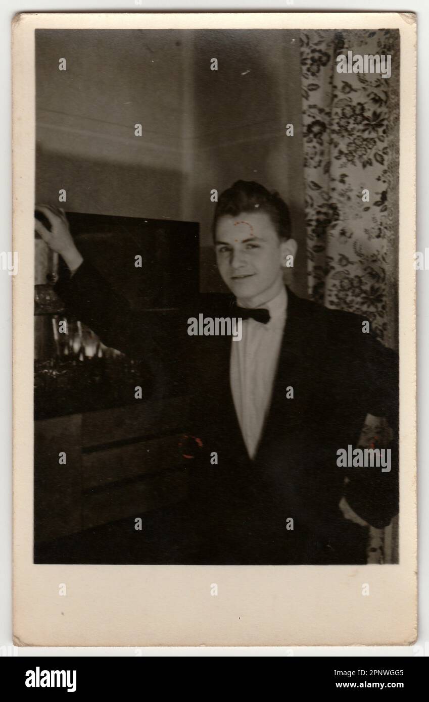 A vintage photo shows young boy wears jacket and bow tie Stock Photo ...