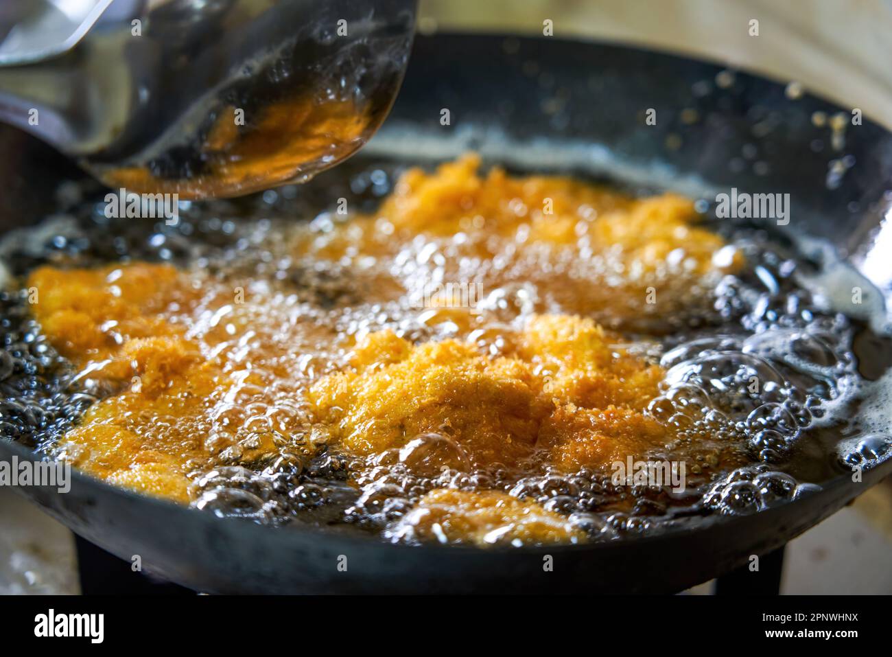 Delicious chicken chops are being fried in the kitchen oil pan Stock ...