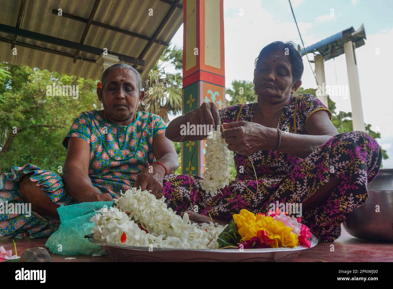 Pakiyam Sebamalai, left, and Solai Valliyamma weave flowers into ...