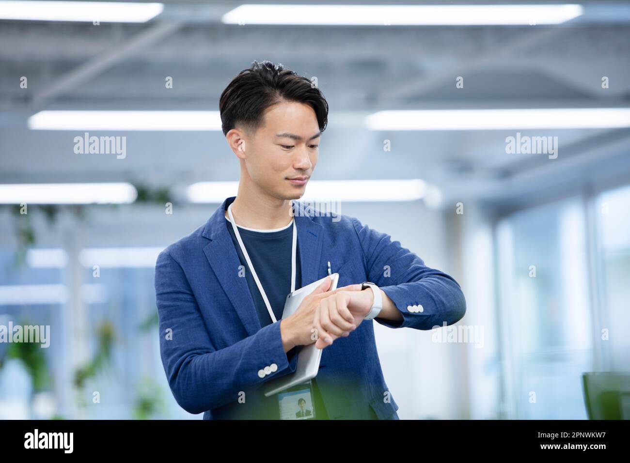 Young businessman looking watch smiling hi-res stock photography and ...