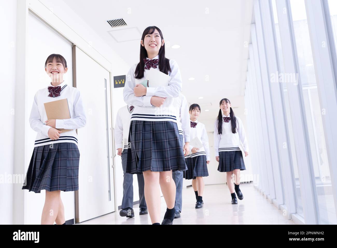 High school students walking in the hallway Stock Photo - Alamy
