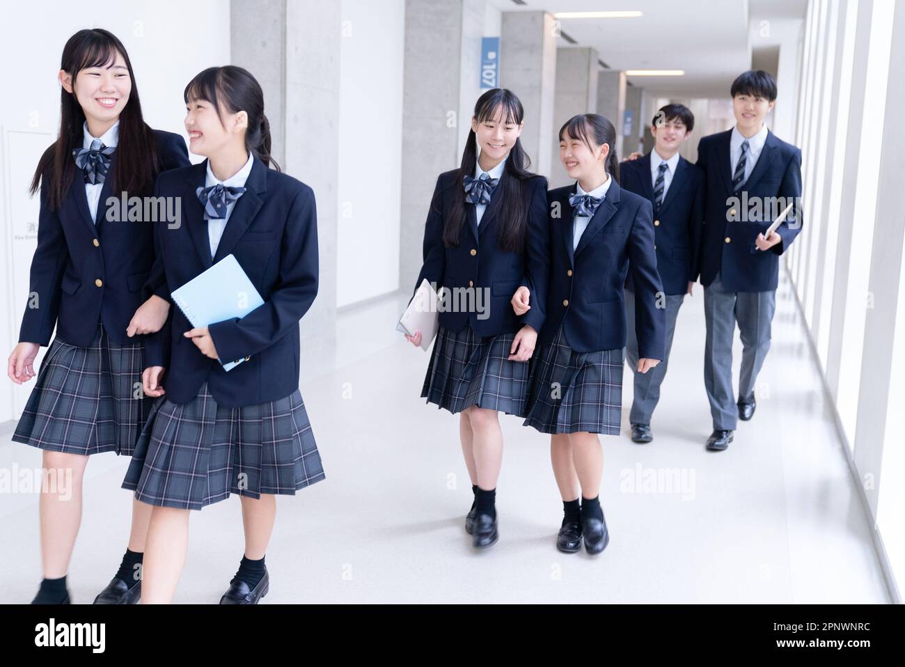 High school student walking in the hallway Stock Photo - Alamy