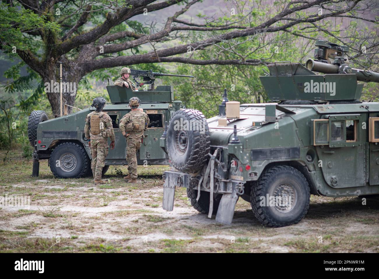 U.S. Soldiers, with the 25th Infantry Division wait behind Humvee ...