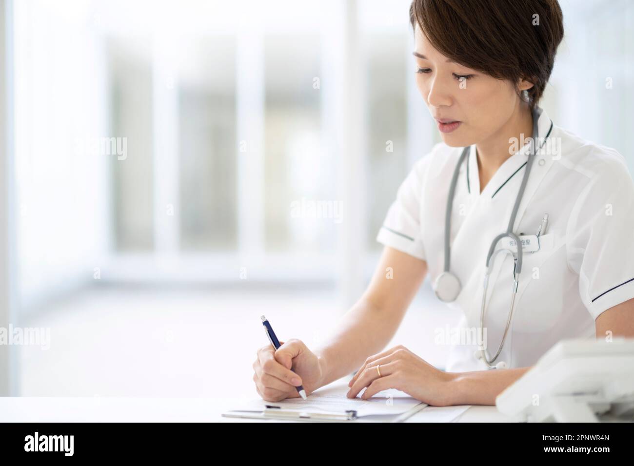 Asian female doctor writing hi-res stock photography and images - Alamy