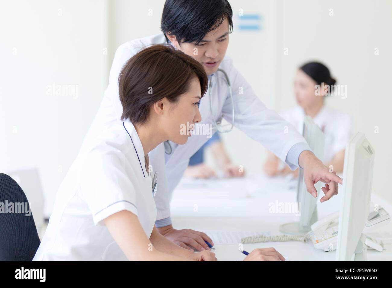 Asian female looking monitor hi-res stock photography and images - Alamy