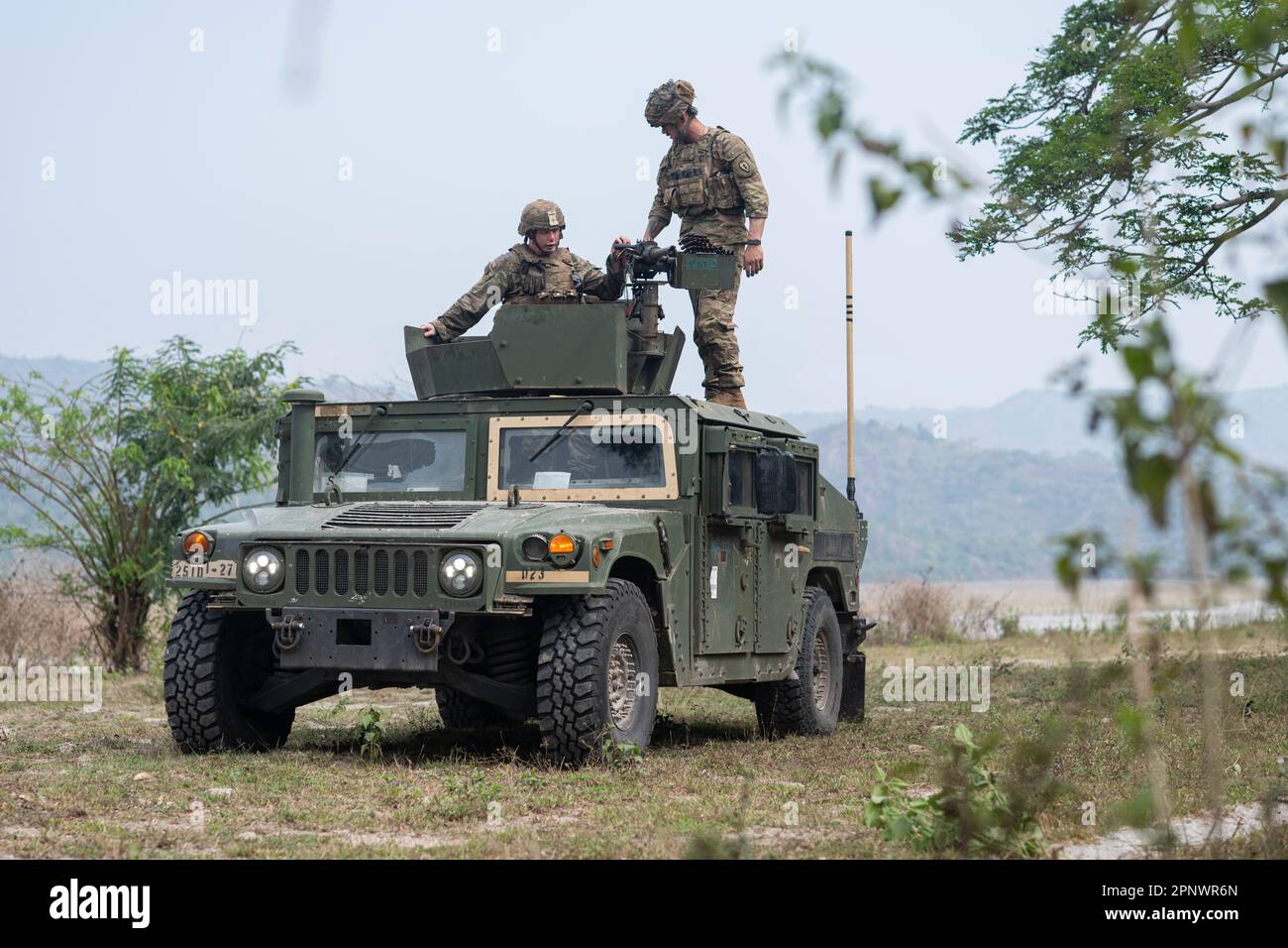 U.S. Soldiers, with the 25th Infantry Division, checks a .50 caliber ...
