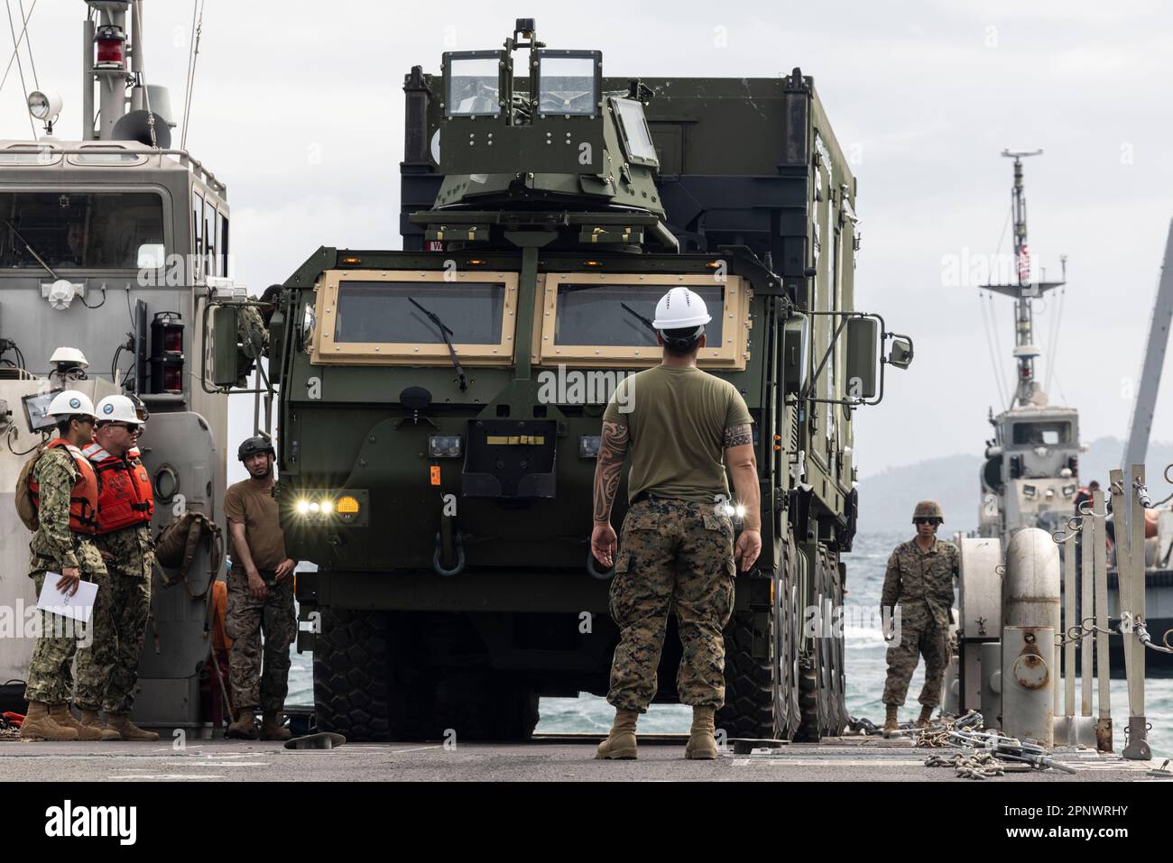 U.S. Marines with 3rd Landing Support Battalion, guide a Logistic ...