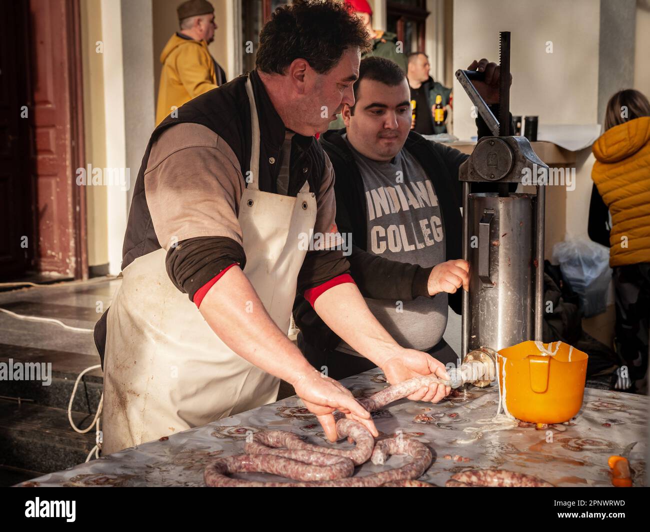 Picture of people in Serbia preparing sausage manually, with a meat ...