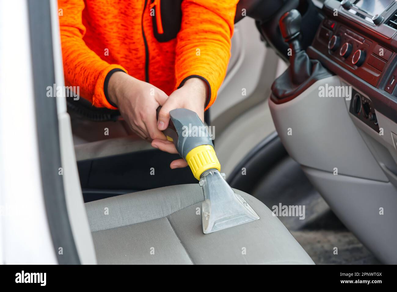 Handyman vacuuming car front textile hi-res stock photography and ...