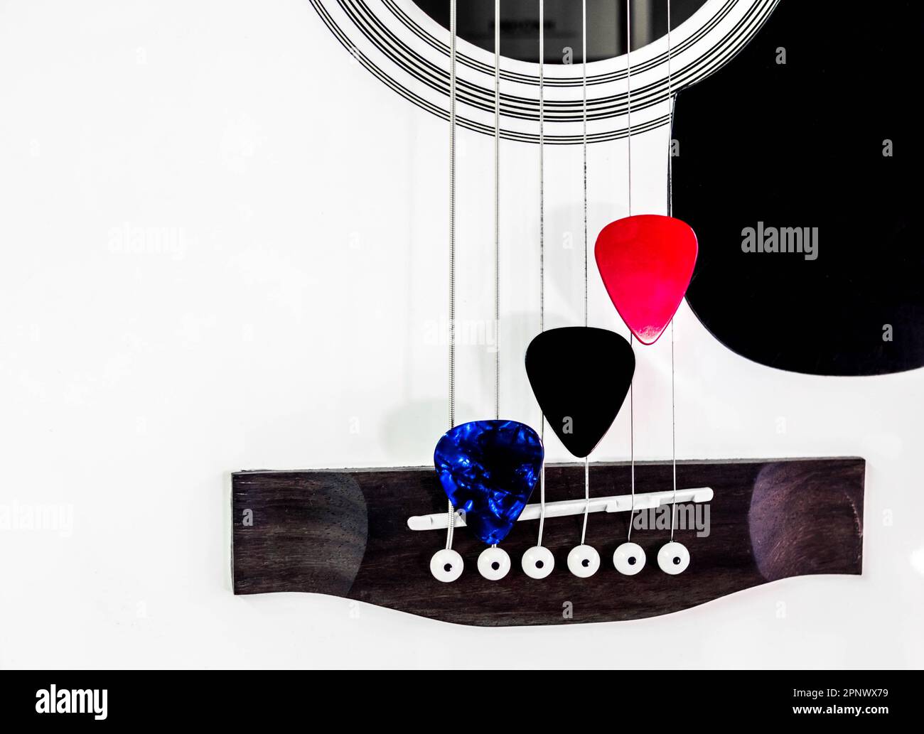 Three pick guitar on white guitar background Stock Photo - Alamy