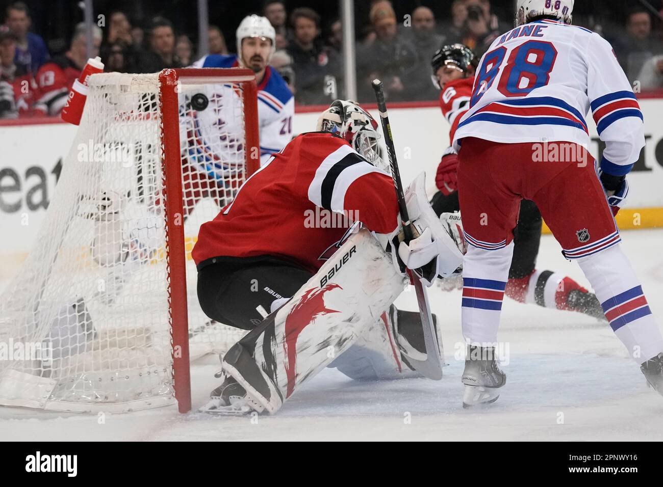 New York Rangers' Patrick Kane, right, scores on New Jersey Devils ...