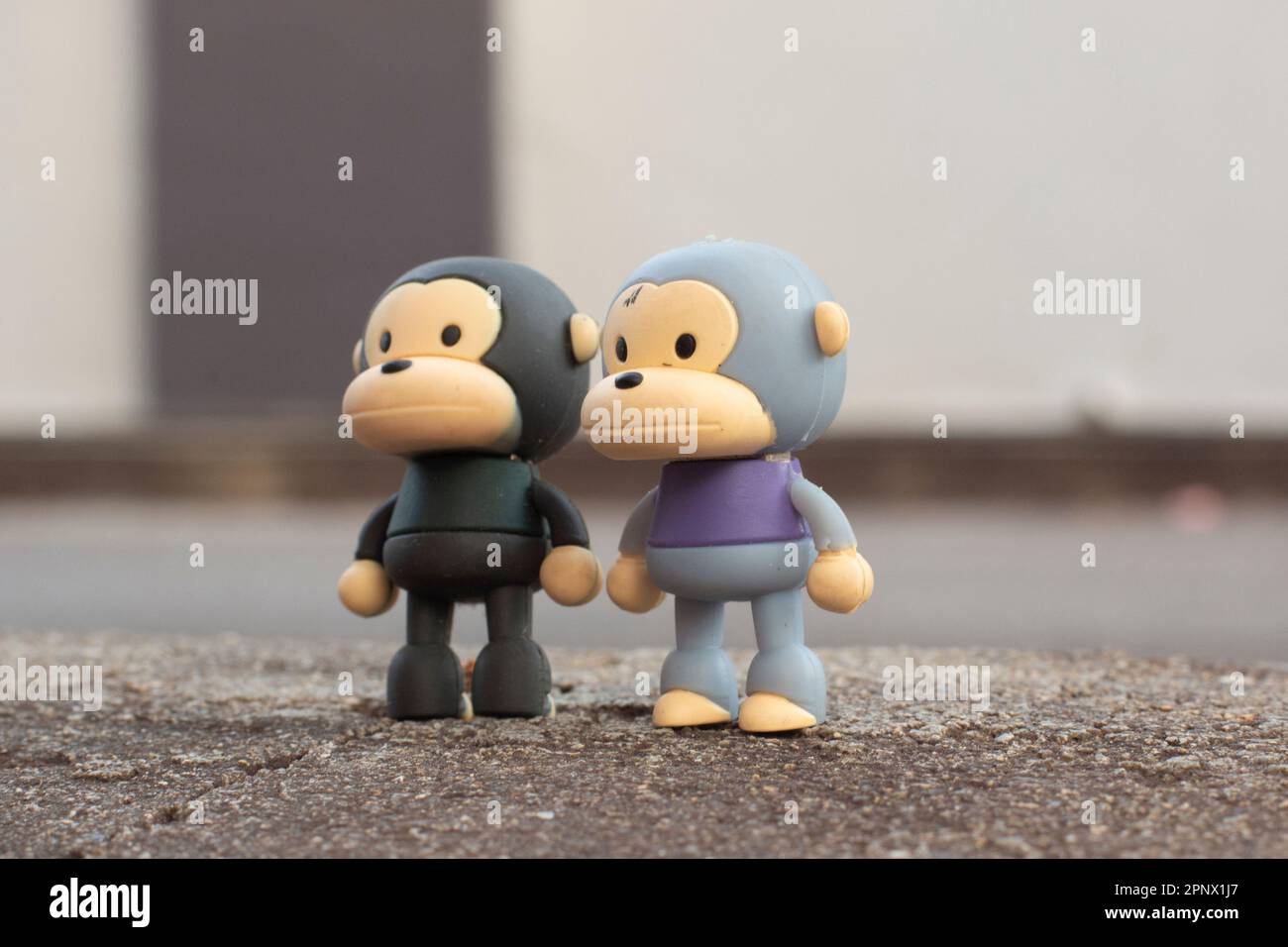 infrared image of the monkey toys on the asphalt street Stock Photo - Alamy