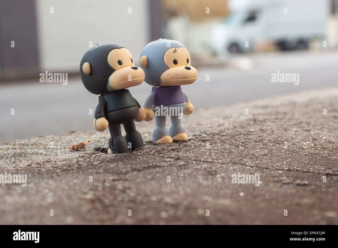 infrared image of the monkey toys on the asphalt street Stock Photo - Alamy